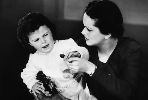 getty_rm_photo_of_woman_giving_child_medicine_vintage – Nursing Clio
